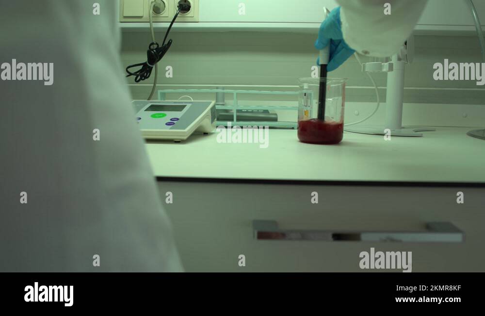 Lab Worker Stirring Fruit Jam Sample In A Glass Beaker. slider right ...