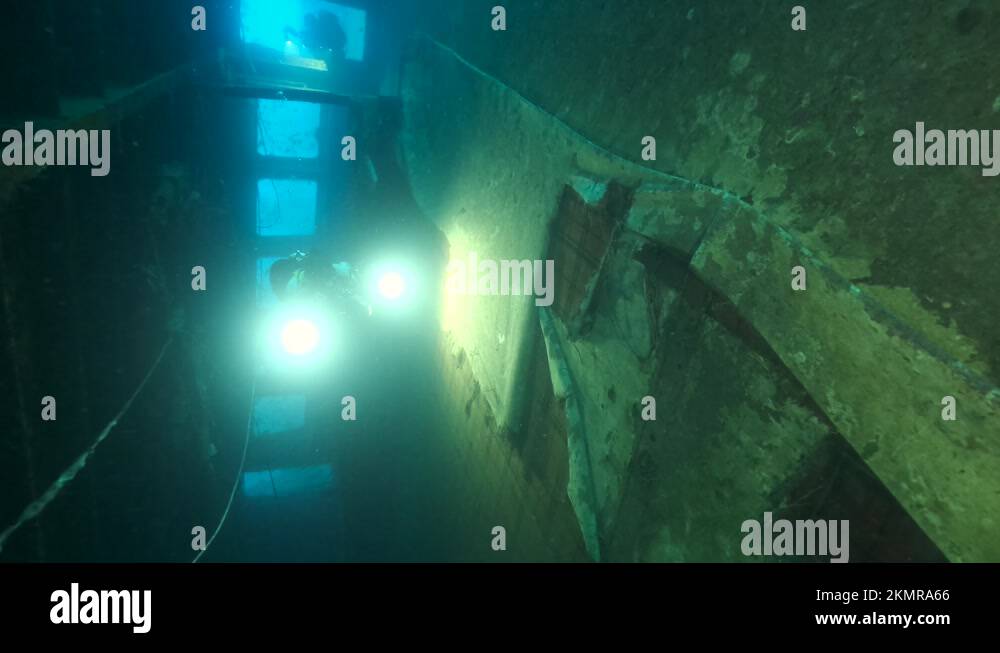 Scuba diver photographer swims inside of the shipwreck Swedish ferry MS ...