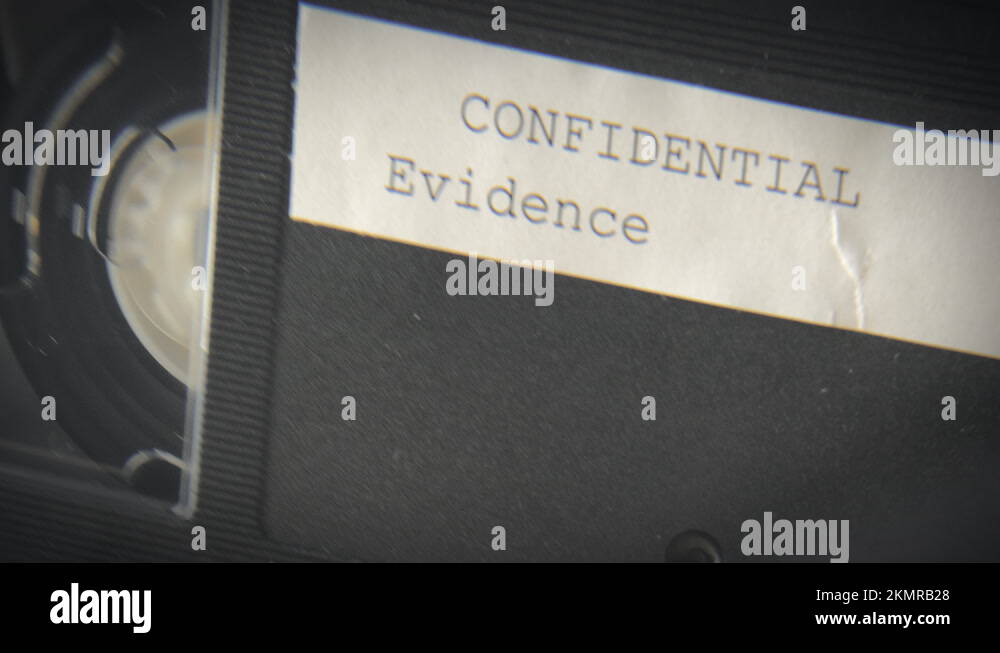 Closeup shot of someone examining an old vhs cassette using a ...