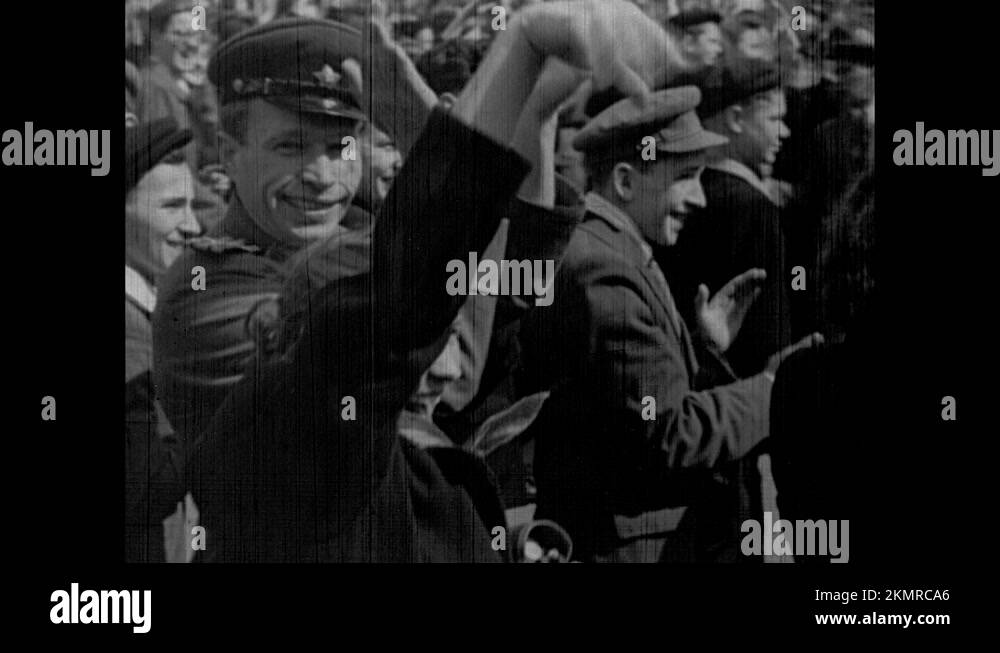 1940s: City. Parade. Joseph Stalin claps and waves. People carry signs ...