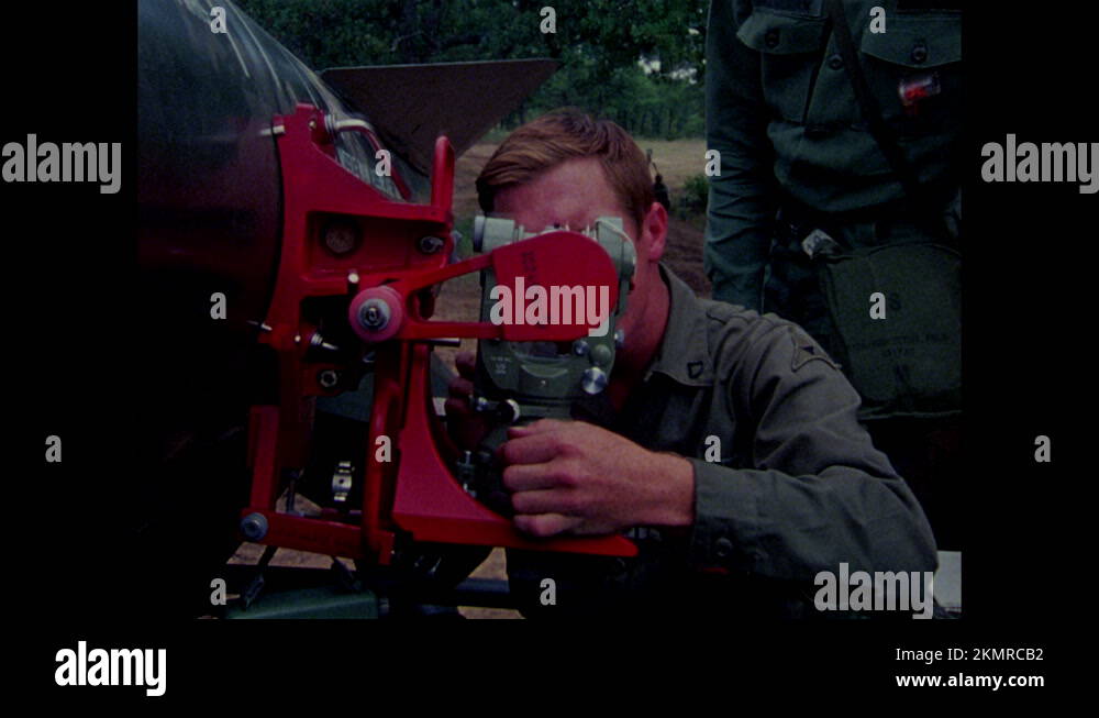 1970s: Soldiers look through scope of missile launcher. Man uses ...