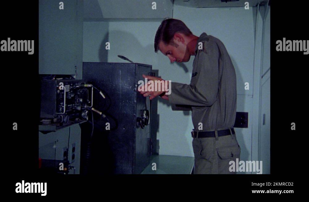 1970s: Men enter codes in safe and take out keys and folder labeled ...