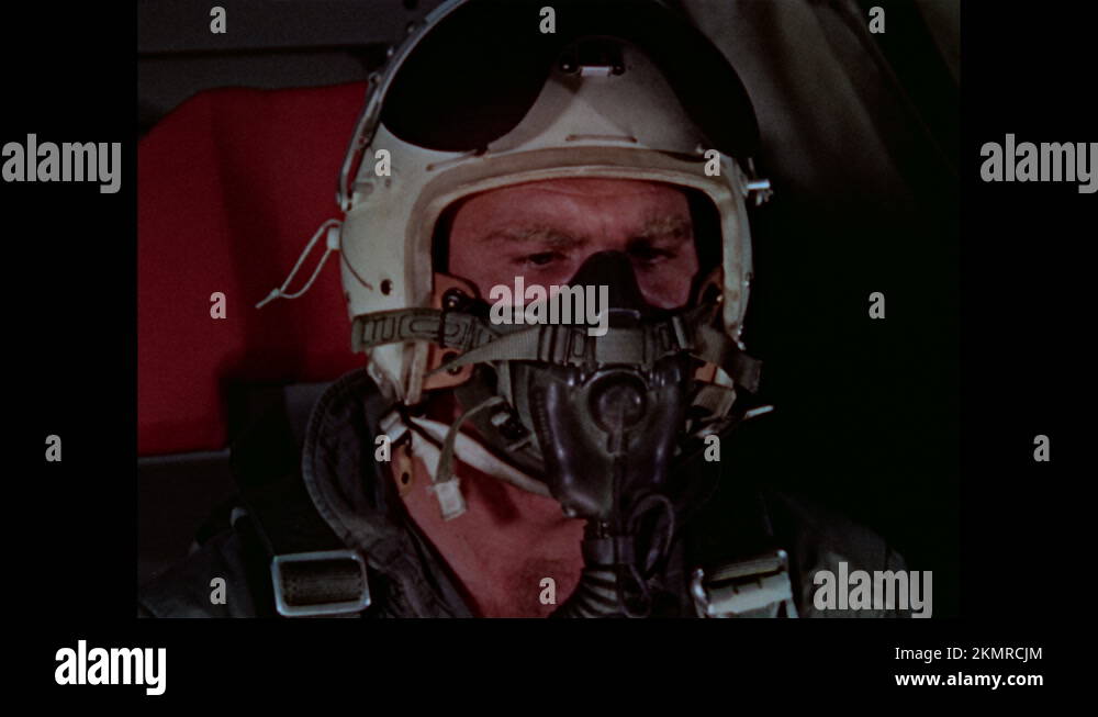 1960s: pilots flying bomber above clouds, looking down at watch, bomber ...