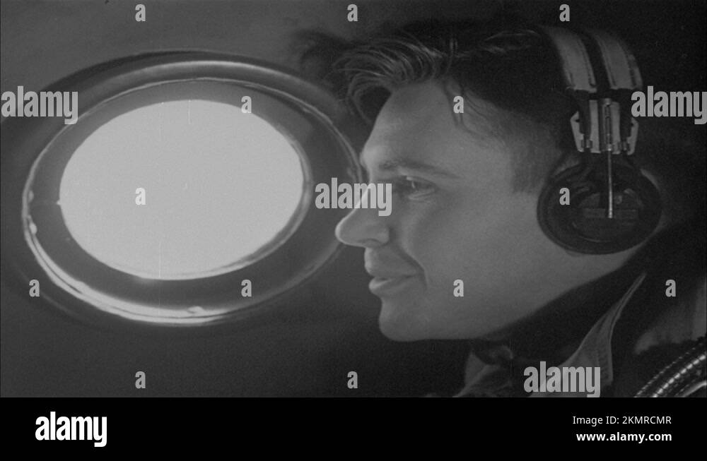 1940s: Pilot in airplane speaks on headset. Pilot in cockpit steers ...