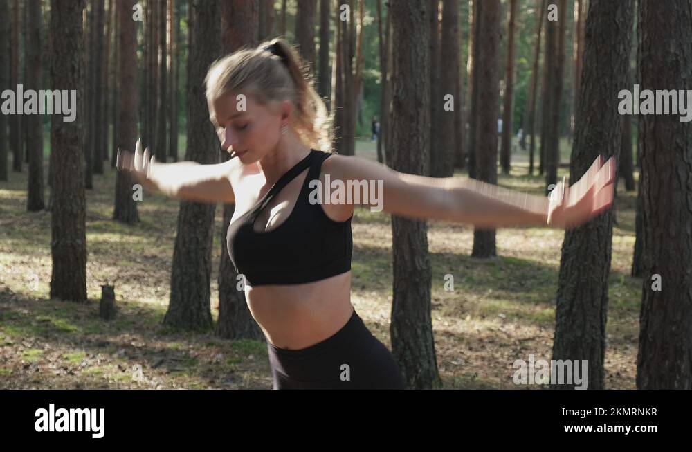 flexible fit girl practices yoga, performs surya namaskar at sunny pine ...