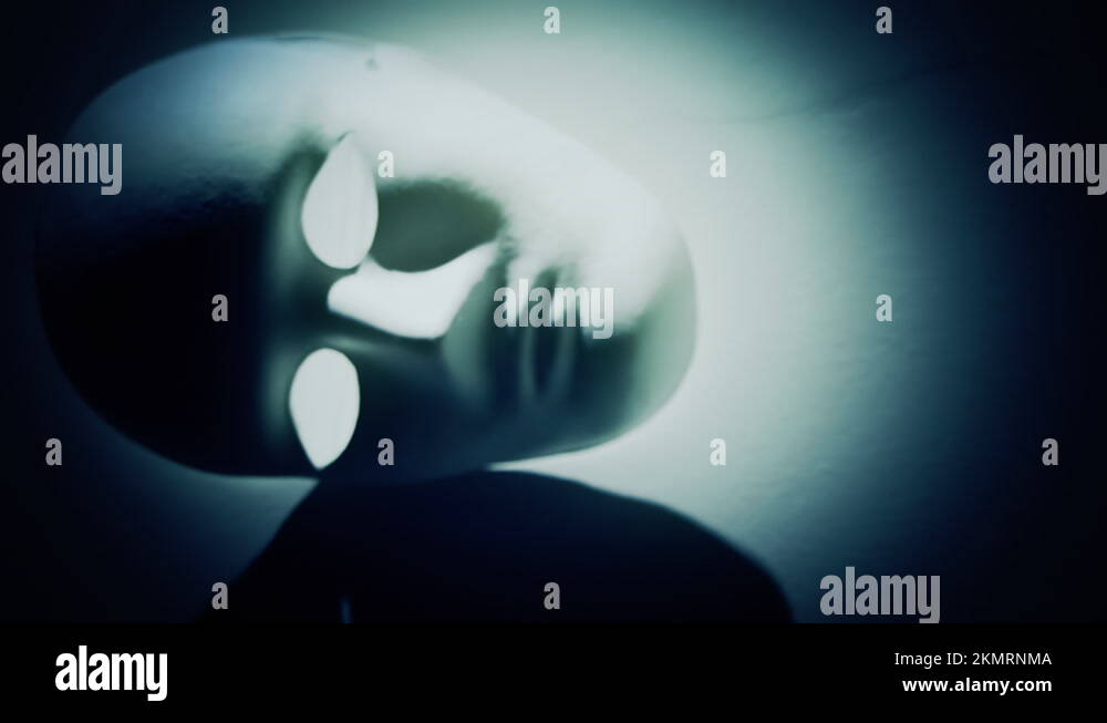 Vertical content: a white mask hanging from a wall, slowly appearing ...