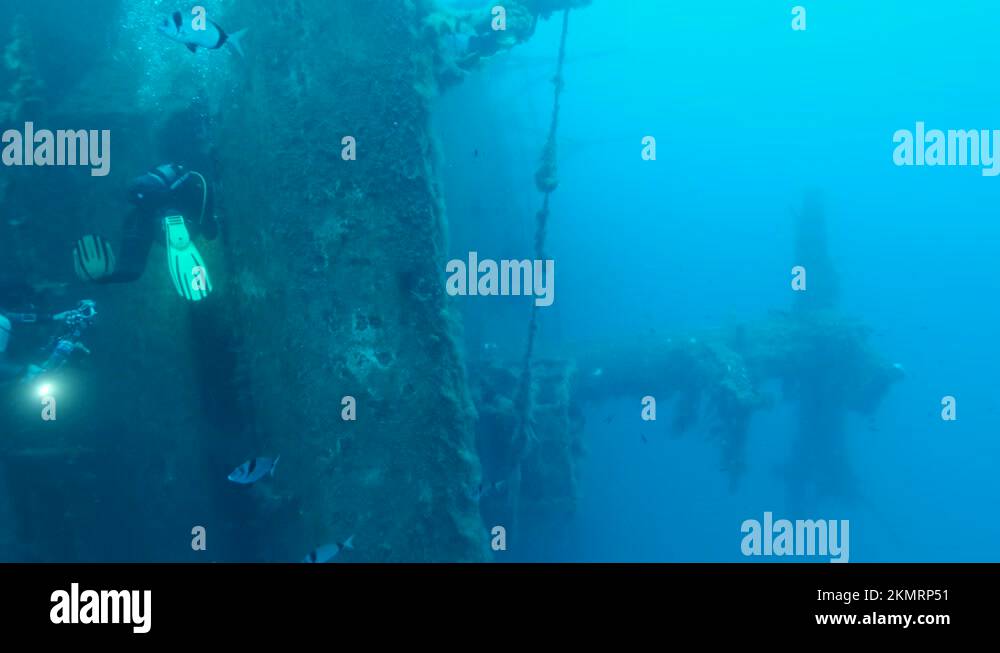 Scuba diver photographer swims on the shipwreck Swedish ferry MS ...