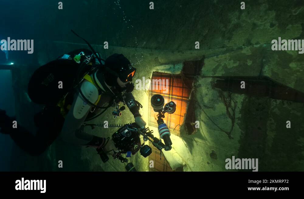 Scuba diver photographer shots red carpet inside of the shipwreck ...