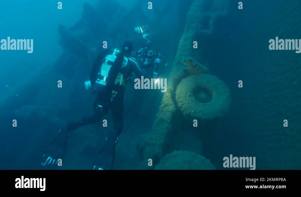 Scuba diver photographer shots truck on the shipwreck Swedish ferry MS ...