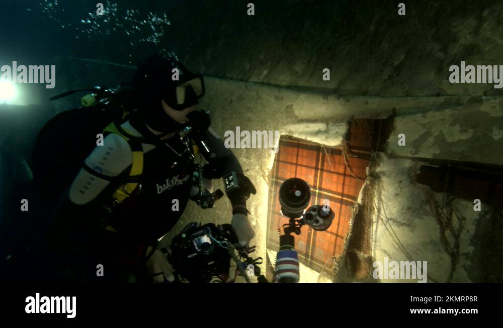 Scuba diver photographer shots red carpet inside of the shipwreck ...
