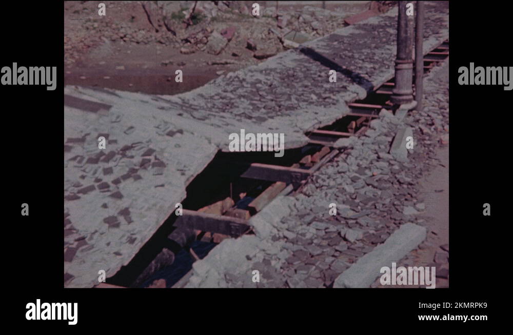 1940s: Buckled concrete lines bridge in bombed out city. Destroyed ...