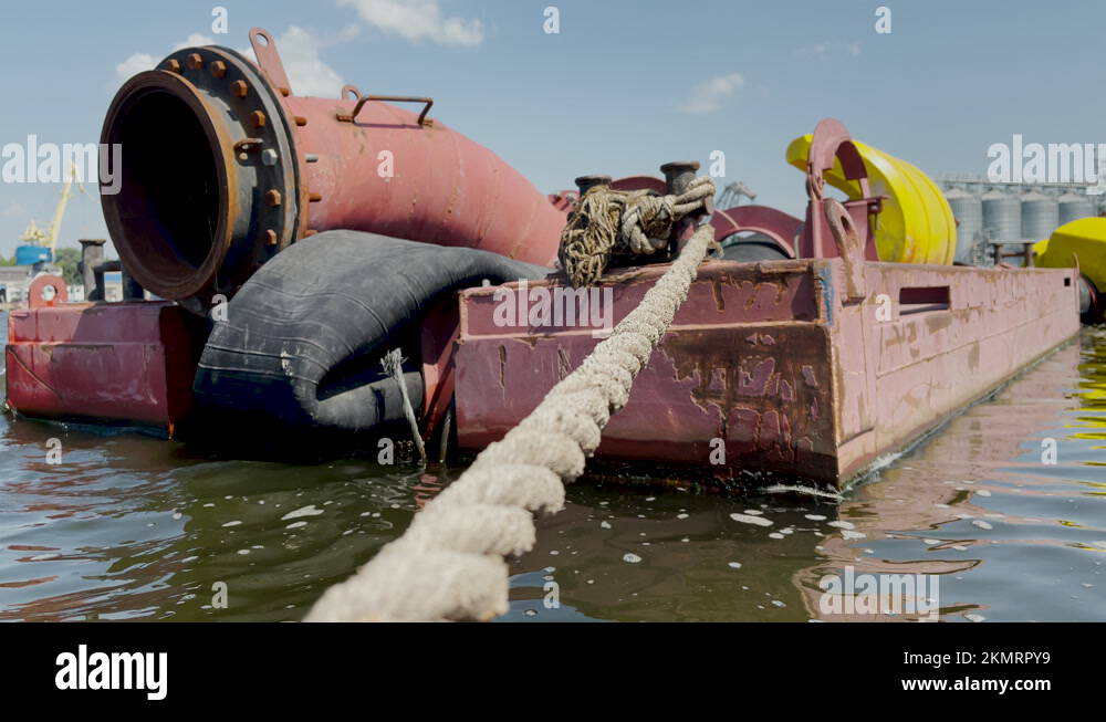 Mooring hemp rope holds old float (nautical, pontoons) with pipe and ...