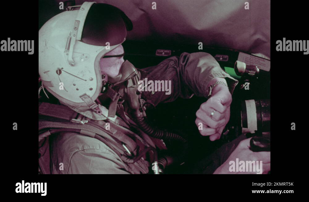 1960s: Slate. Pilot wearing an eyepatch checks his watch. He moves the ...