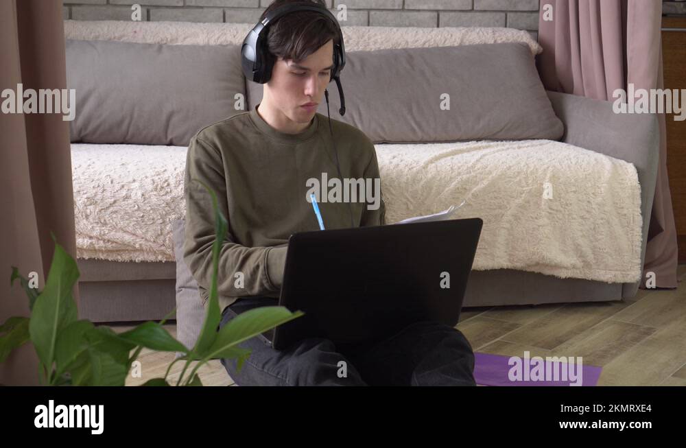 Student with headphones and a microphone study online at home Stock ...