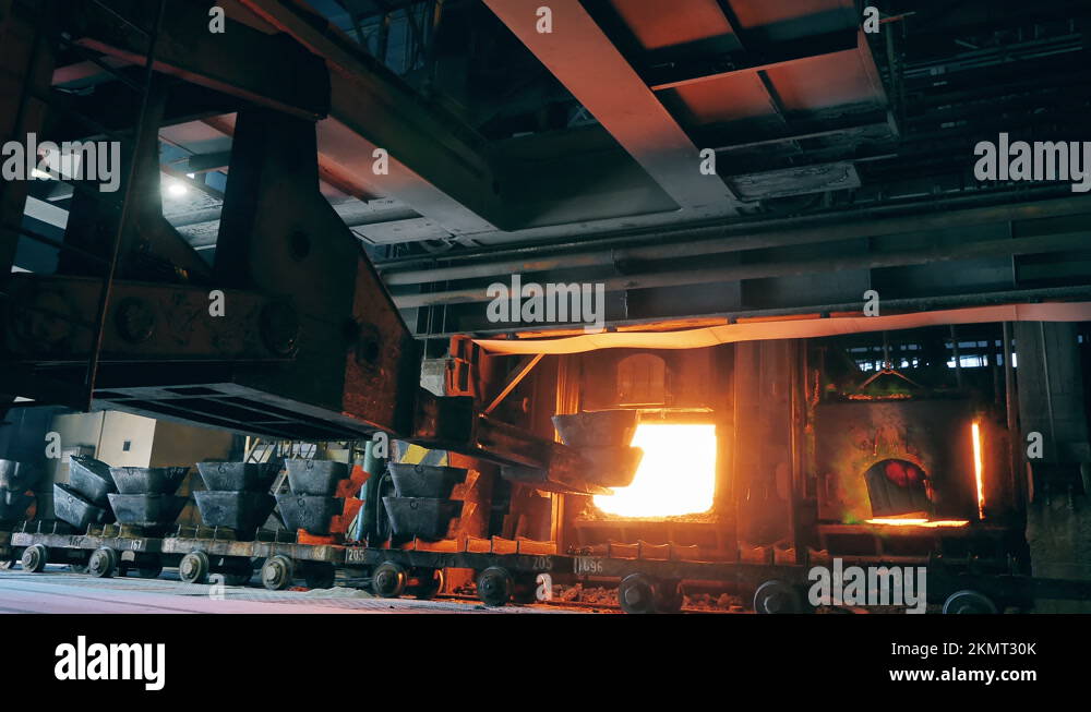 Foundry furnace with industrial mechanism loading metal into it Stock ...
