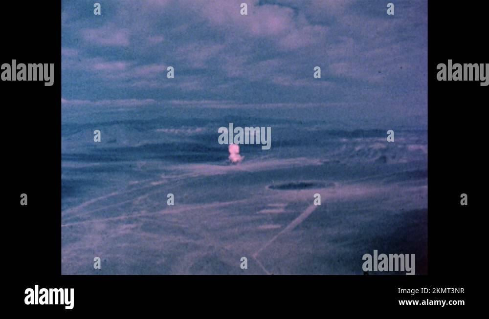 1960s: Looking down on desert, atomic bomb explodes, mushroom cloud ...