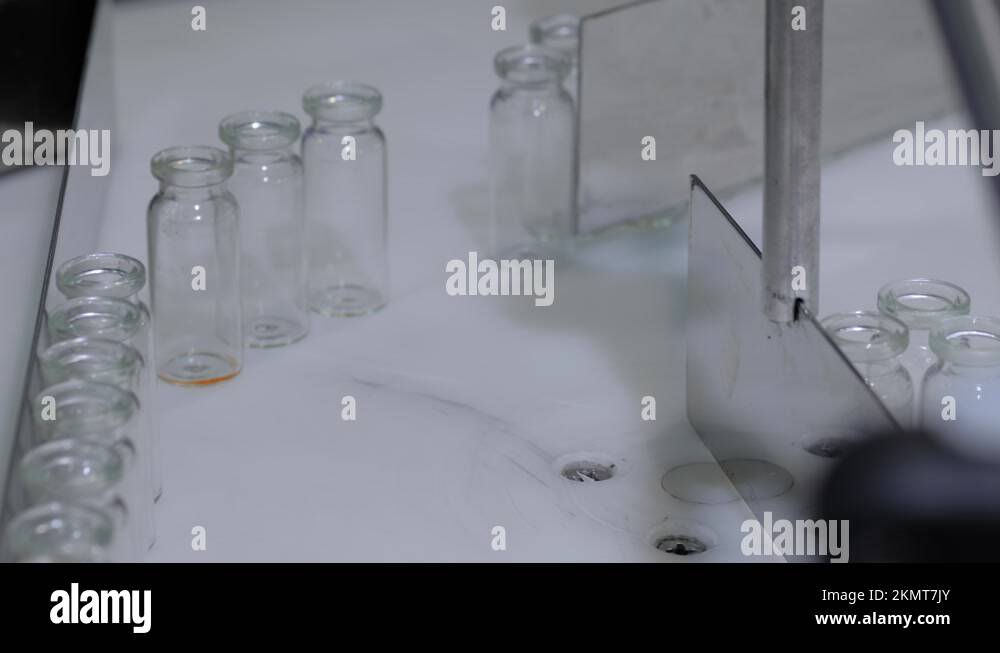 Pharmaceutical concept - conveyor belt with empty injection glass vials ...