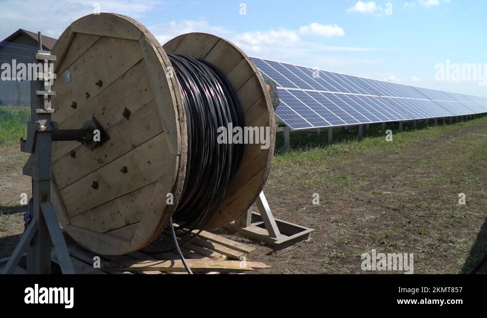 Solar panels in the background of a roll of cable, construction of ...
