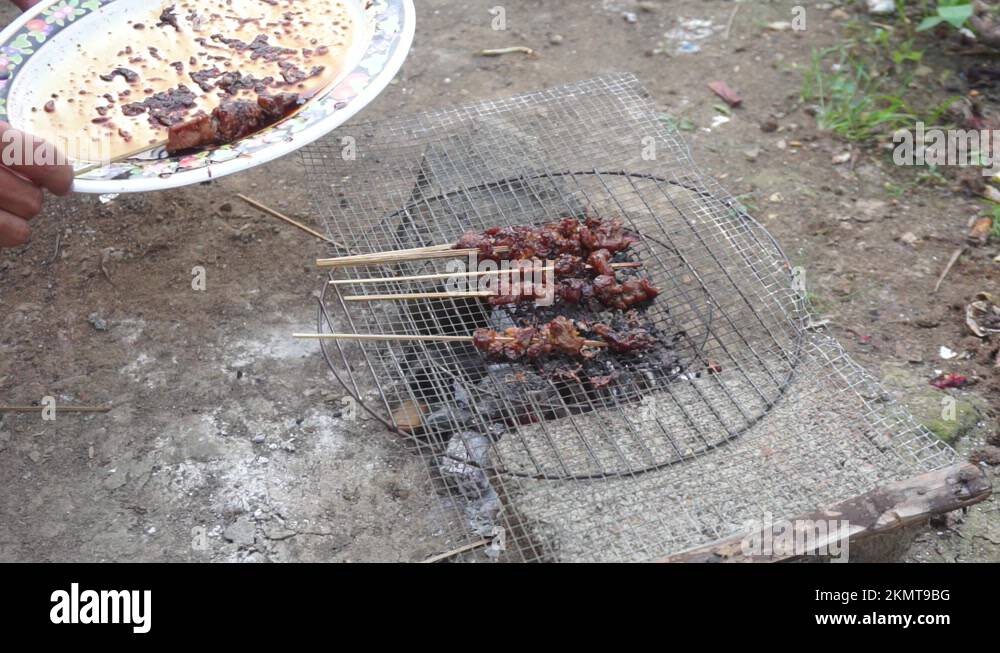 Process of roasting satay on charcoal stove, traditional Indonesian ...