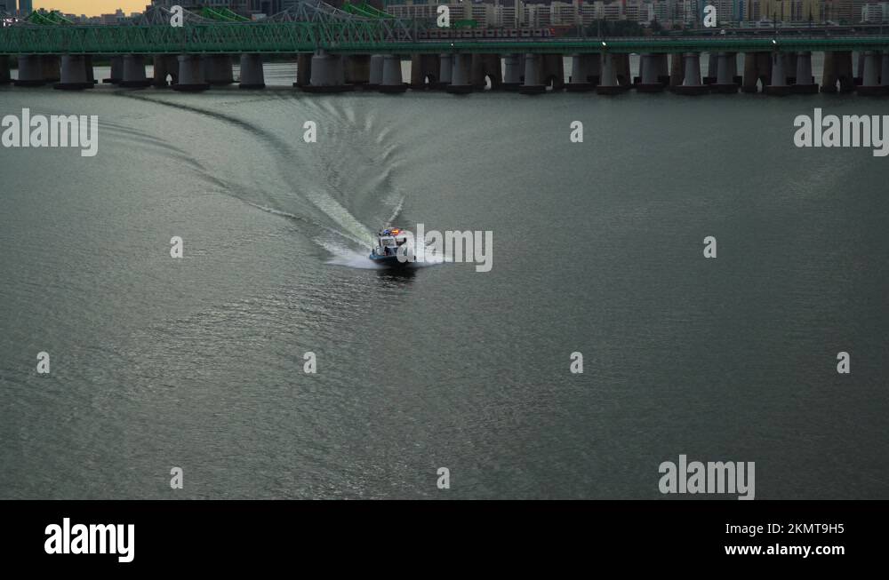Water Police Boat With Blinking Blue And Red Lights Sailing Across The ...