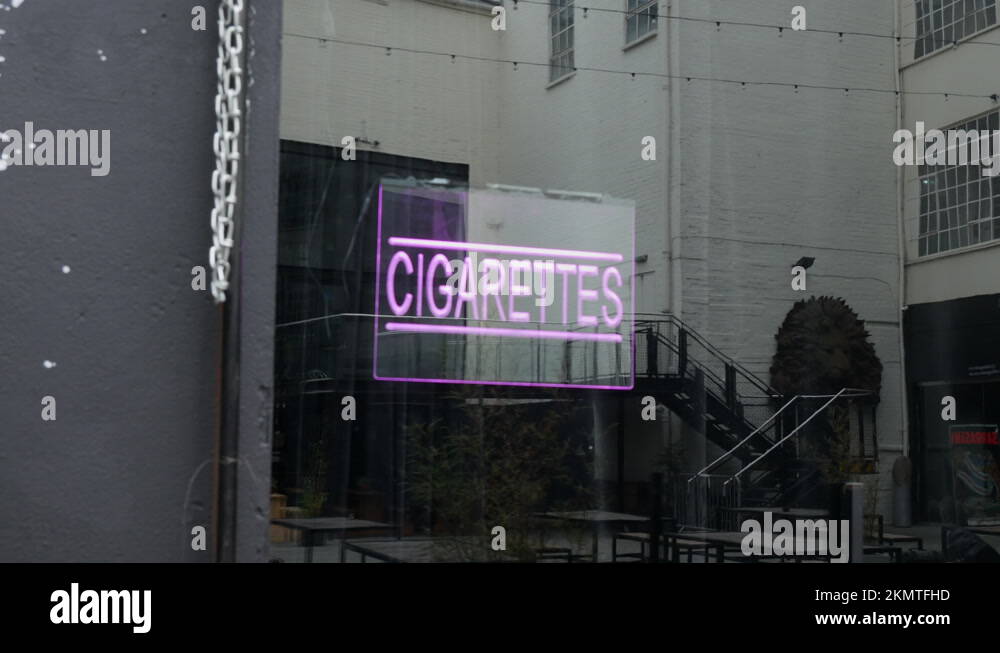 Cigarettes pink neon sign advertising in store window Stock Video ...