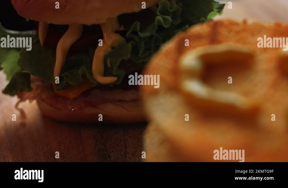 Taste Classic American burger. Happy mustard smile over burger bread ...