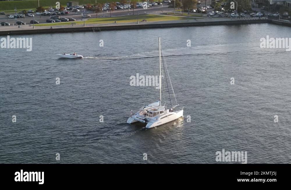 Catamaran Boat Sailing At Lake Pontchartrain With Traffic On Lakeshore ...