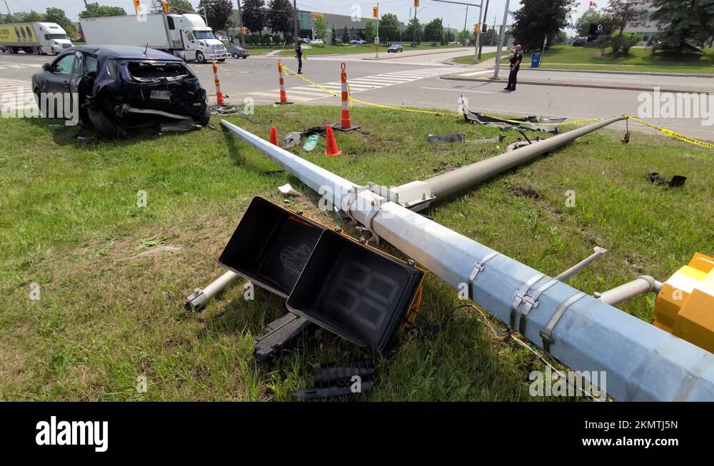 Scene of a two car collision were a traffic signal was knocked down ...