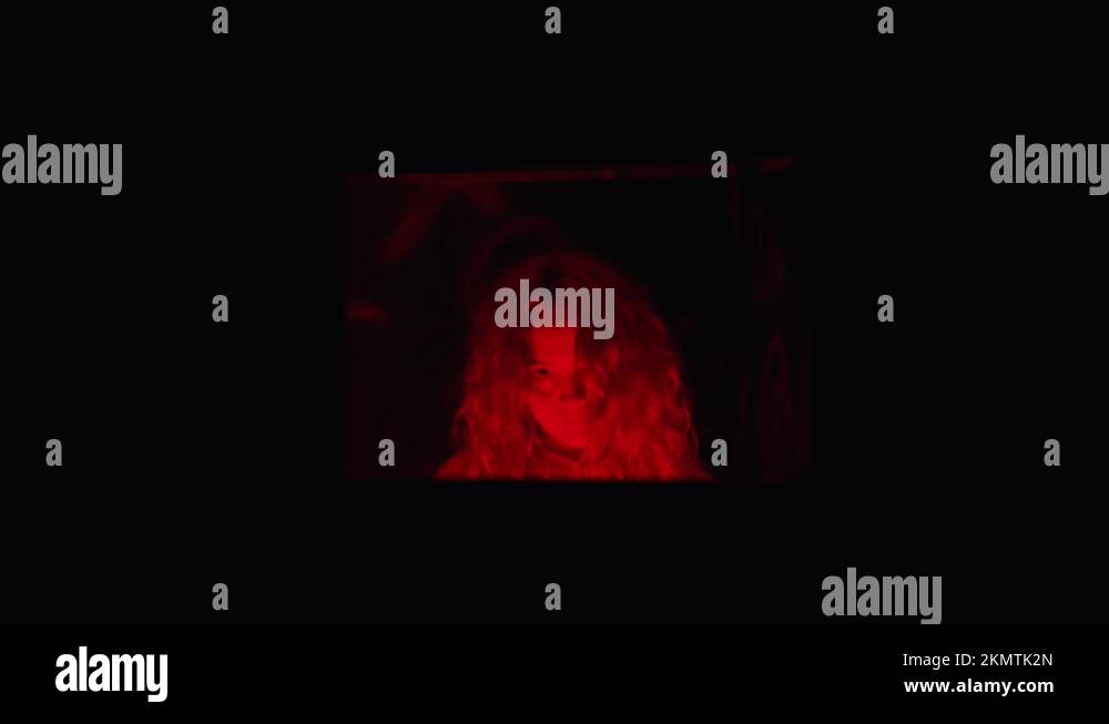 Horror acting - a woman in a straitjacket standing behind the door in ...