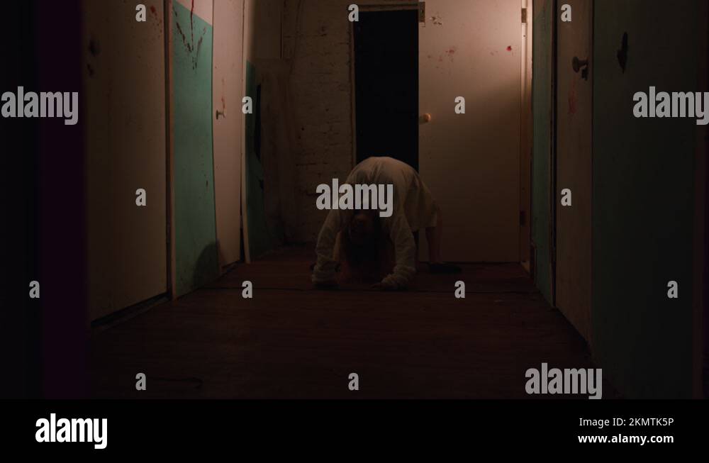 Horror acting - a woman in a straitjacket going crazy in bloody ...