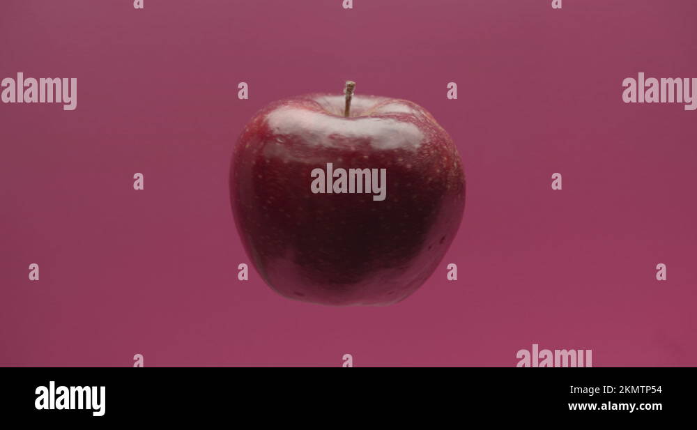 A apple rotate on red background, for commercial creative fruit juice ...
