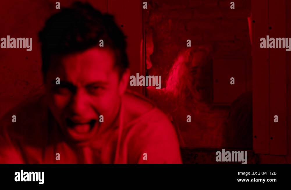 Crazy man sitting in the mental hospital in straitjacket and screaming ...