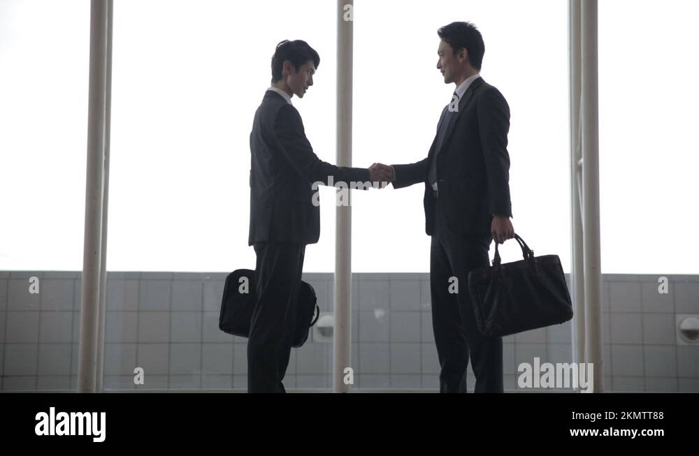Two men in a suit handshake Stock Video Footage - Alamy