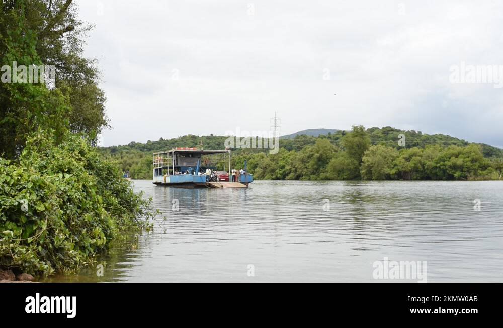 Locals onboarding the ferry boat on foot and on their vehicles Stock ...