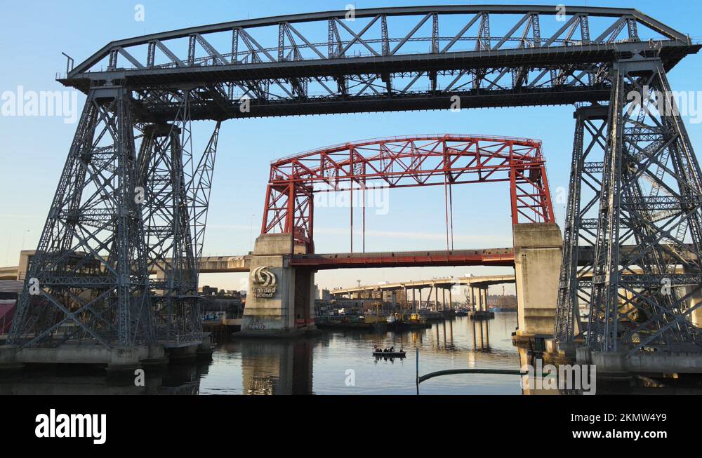 Static view of small boat on water under famous bridges, Buenos Aires ...