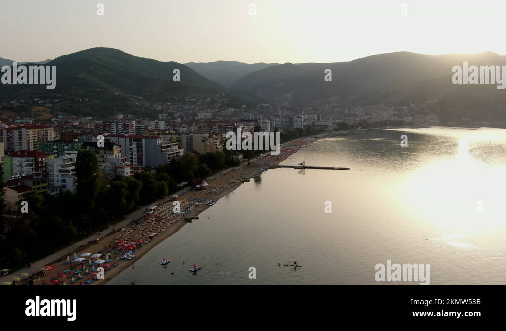 Touristic beach on coastline of Pogradec, golden hour over Lake Ohrid ...