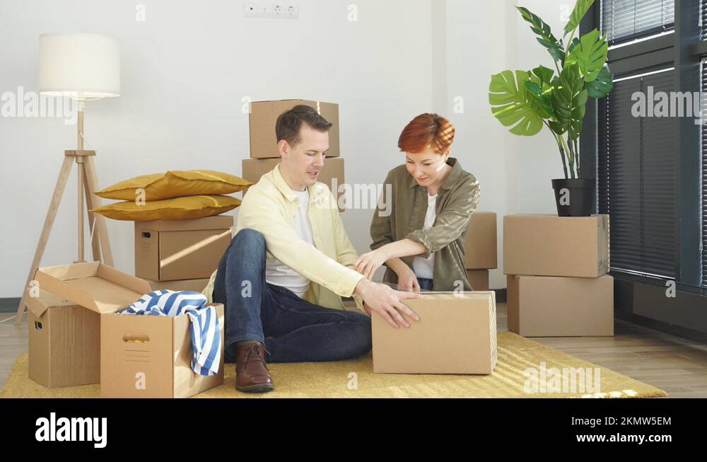 Man And Woman Help Each Other To Pack Stuffs And use Scotch Tape A Box ...