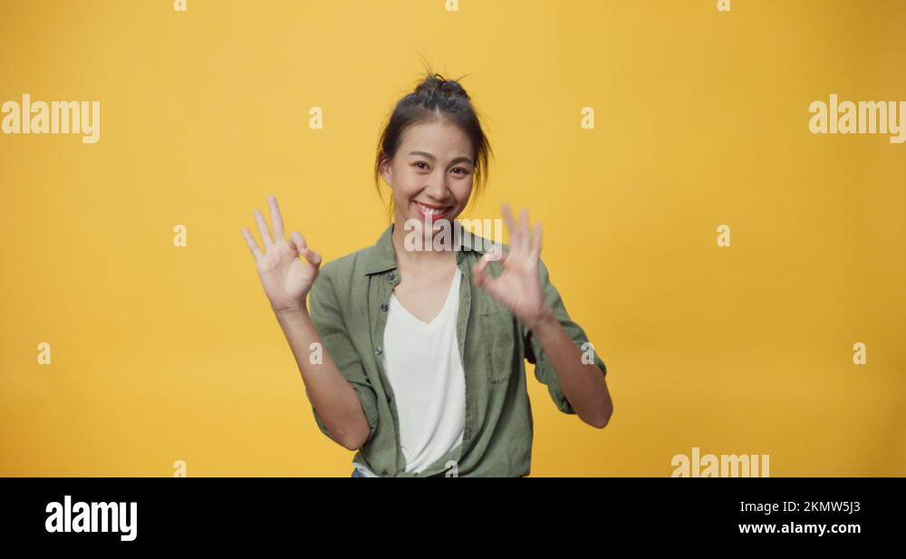 Asia youth lady cross arm stand over isolate yellow empty space background Stock Video Footage ...