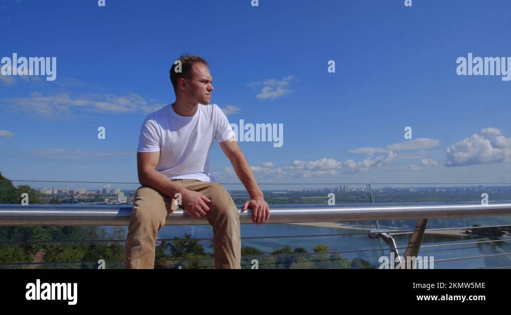guy sitting on the railing of the glass bridge Stock Video Footage - Alamy