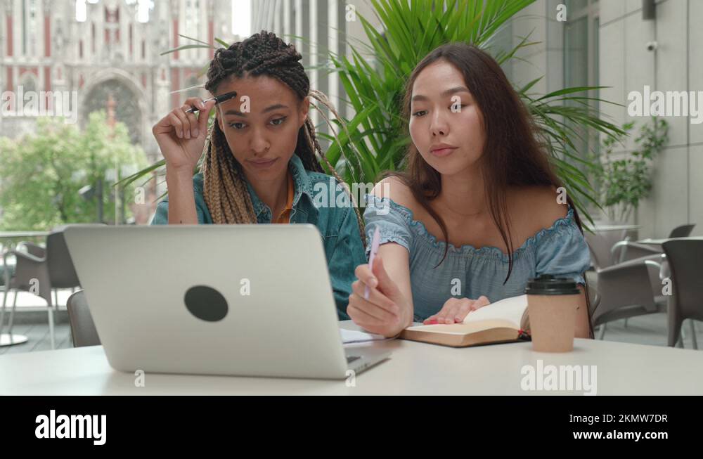 Charismatic student y and her colleague lady long hair studying ...