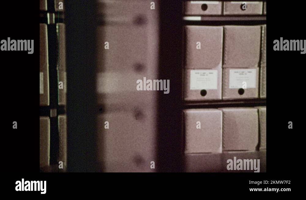 1940s: Document boxes sit on library stack shelves. Labels on document ...