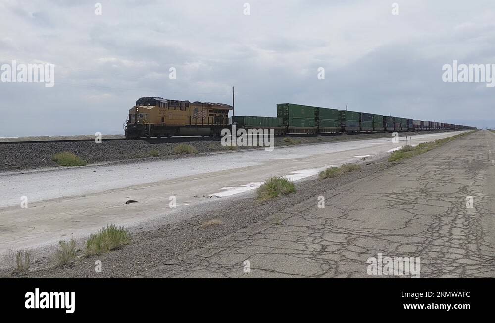 Freight train along Interstate 80 freeway in Utah. Transports ...