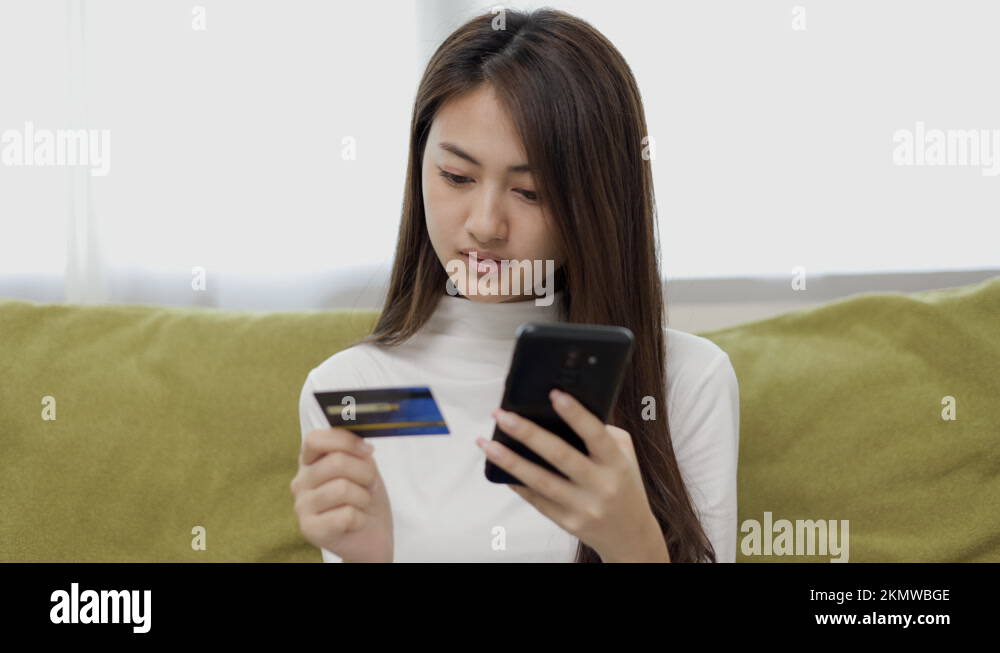 Shopping online. Young asian teenage girl input the serial number of ...