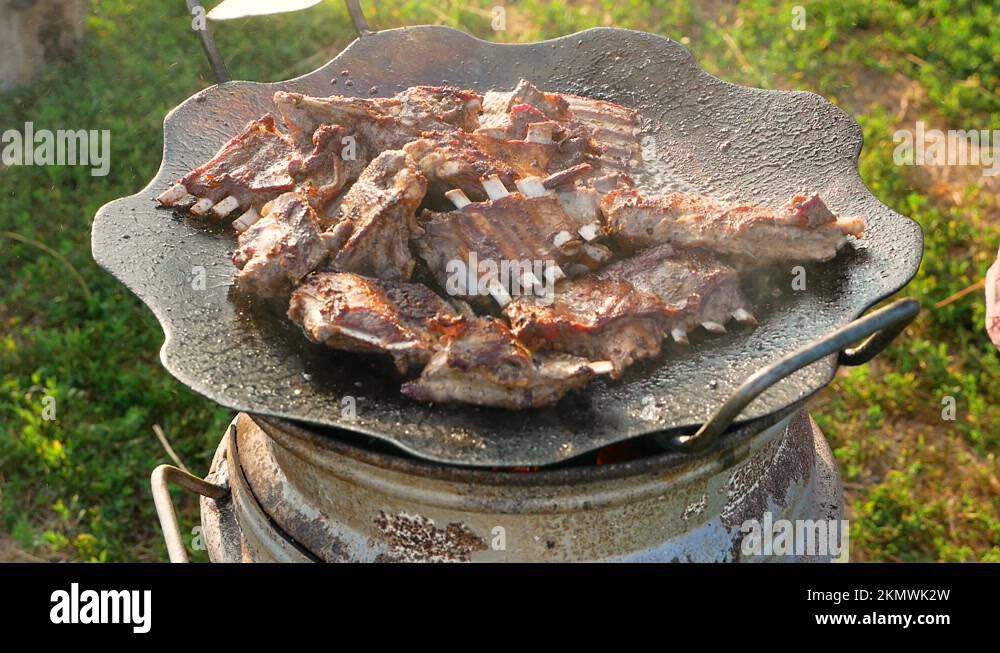 Close-up of goat meat fried on a fire. Grilled sheep ribs. Goat meat is ...