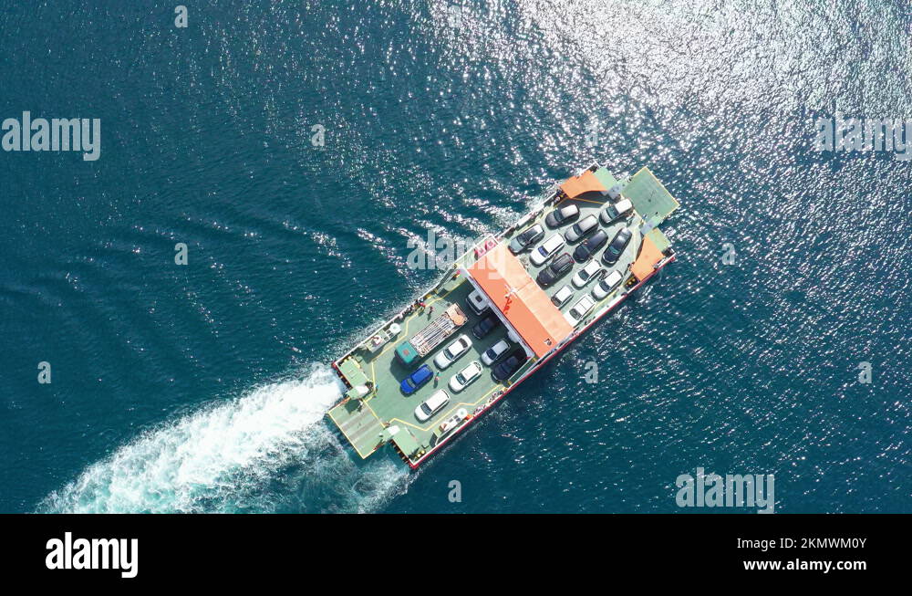 Ferry on the sea, transporting cars: boat carrying vehicles. Sun ...