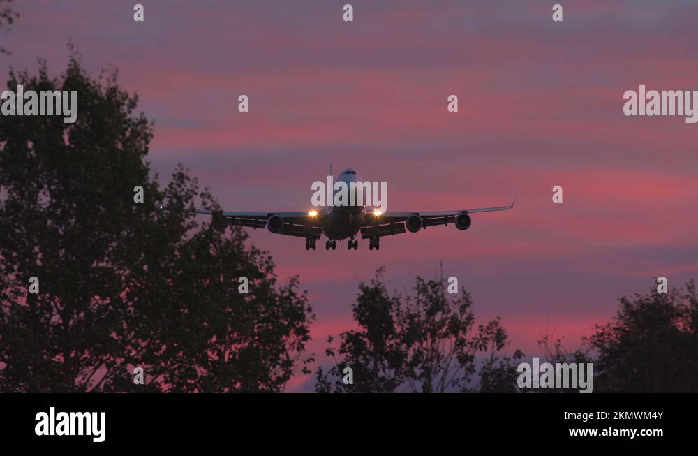 huge cargo airplane boeing 747 jumbo jet arrival red night sky front ...