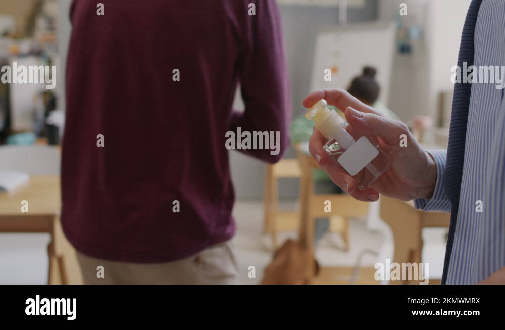 Teacher Putting Sanitizing Hands of Kids in Class Stock Video Footage ...