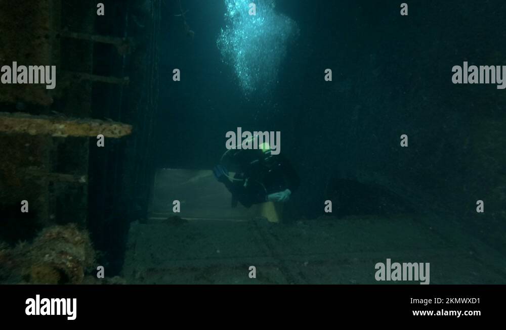 Scuba diver swims inside of the shipwreck Swedish ferry MS Zenobia ...