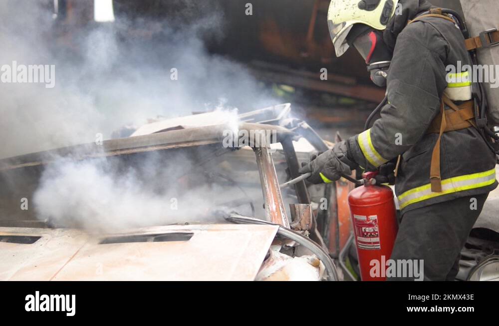 On the Car Crash Traffic Accident Scene: A fire rescue worker ...