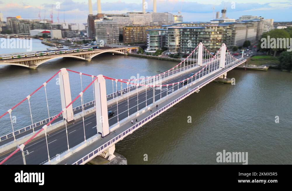 Chelsea Bridge across River Thames, modern buildings on waterfront ...